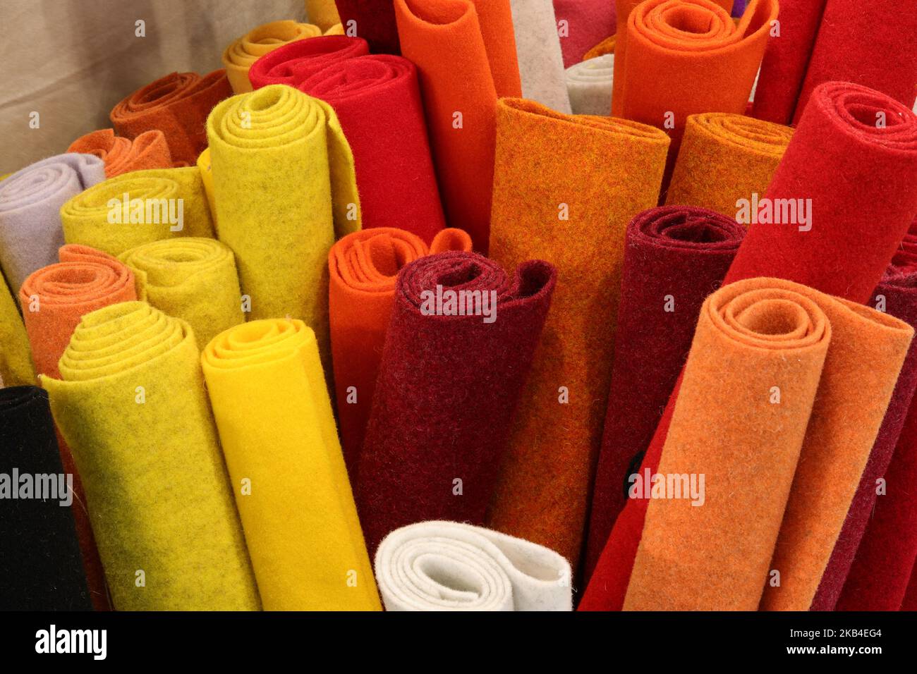tubes of fabrics and colorful cloths and for sale in the cloth shop ...