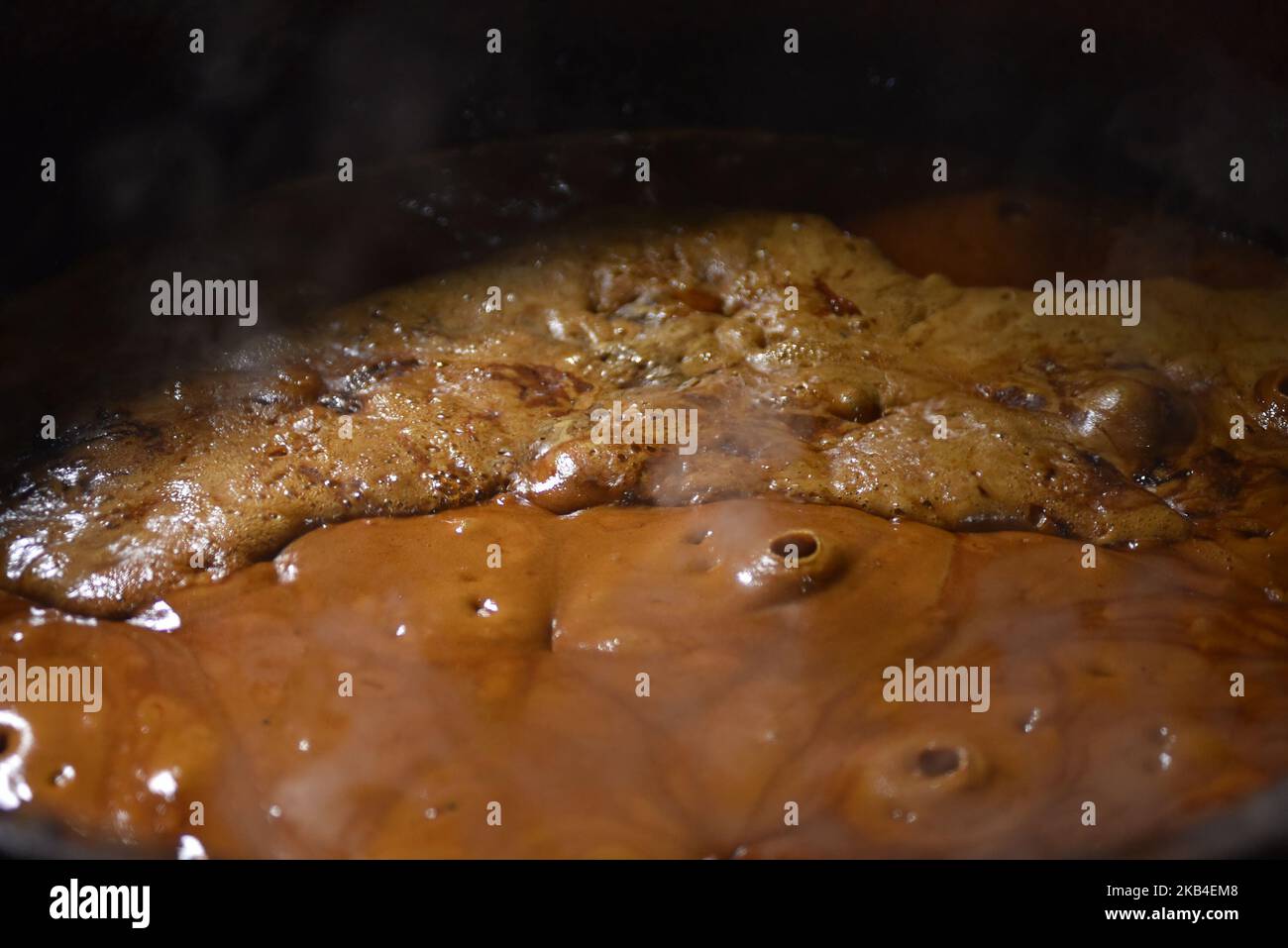 Raw Hard molasses boiling to prepare molasses “Chaku” at Tokha ...