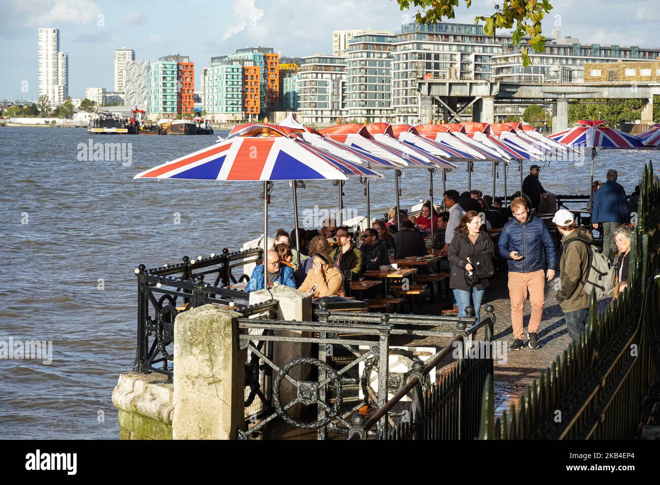 People dining along the River Thames, outside Trafalgar Tavern pub in ...