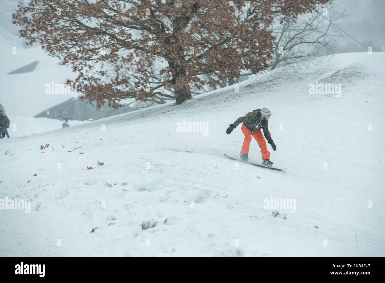 Snowboarders running down the hill. Many persons used the snow and the ...