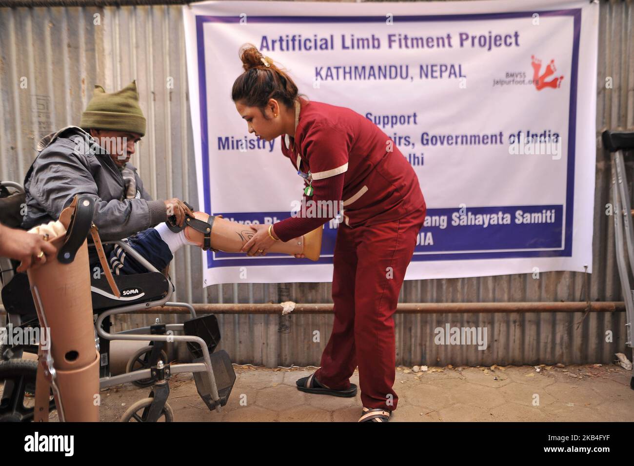 A Nurse helps to fit artificial Prosthetic legs during Artificial limb ...