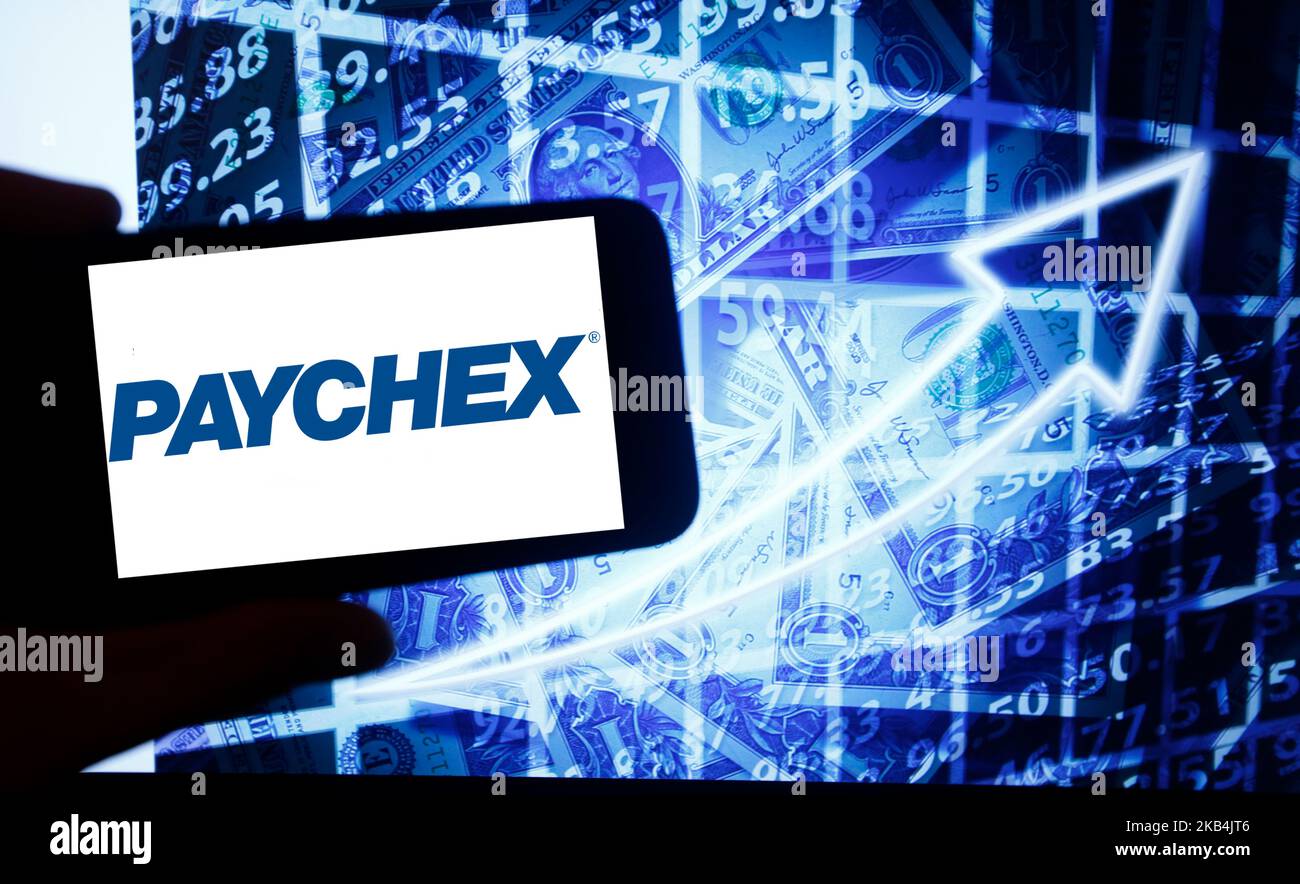 The logo of Paychex is seen on a screen of a smartphone next to a ...