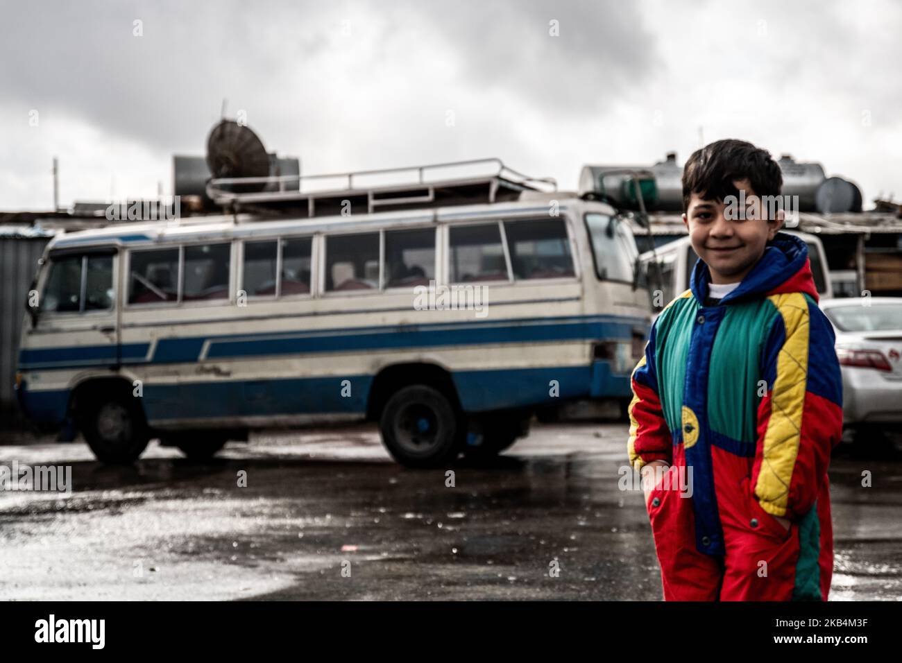 A young boy staring in front an old bus close to Sulaymaniyya bazar On ...