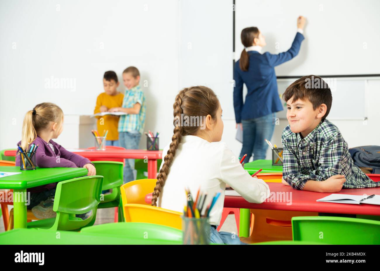 Cheerful pupils during break in classroom Stock Photo - Alamy