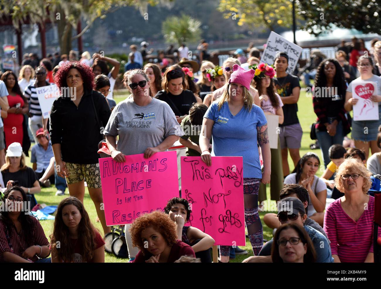 Protesters with signs listen to speakers after marching in the third ...