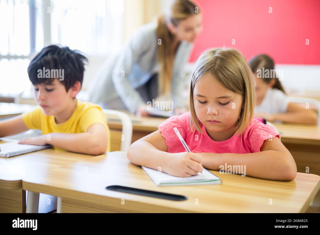 Kids sitting in classroom Stock Photo - Alamy