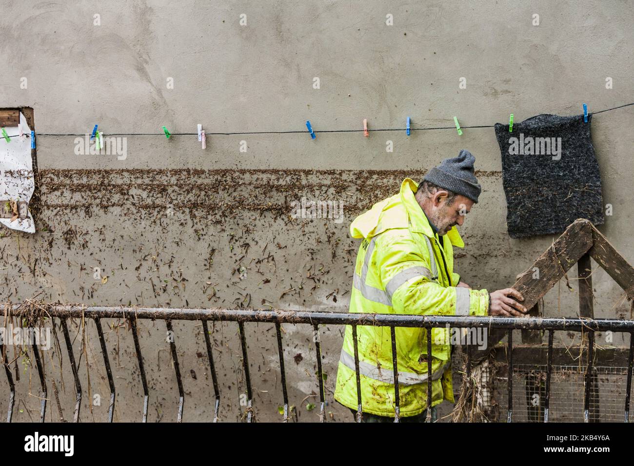 Man cleans his flooded home of mud in Mazcuerras village during the ...