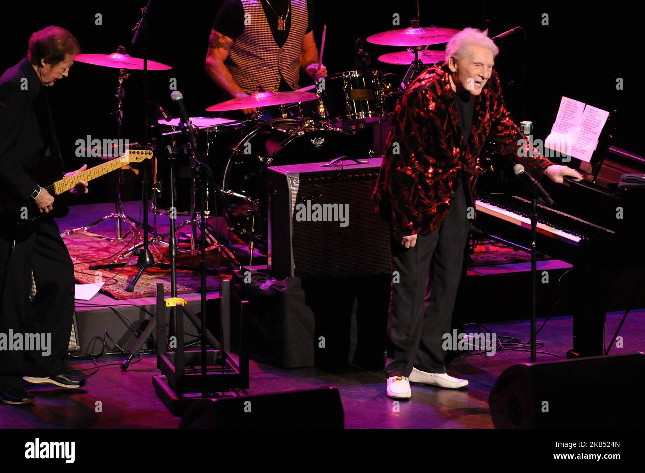 Rock and roll pioneer Jerry Lee Lewis stands after kicking over his ...