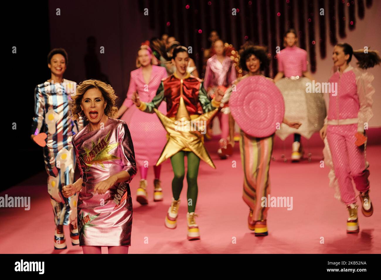 Spanish designer Agatha Ruiz de la Prada (L) walks on the catwalk with ...