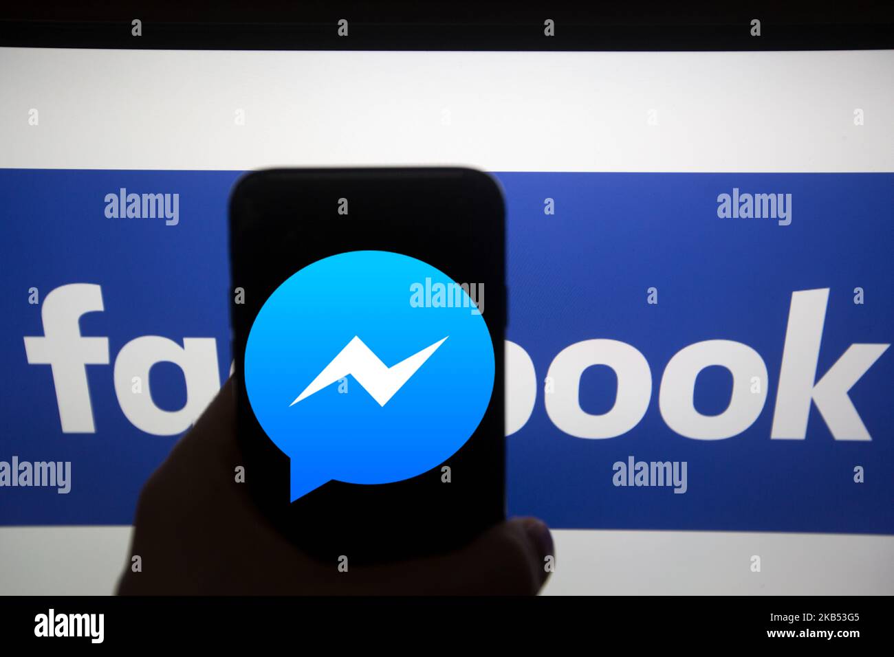The logo of the Facebook Messenger is seen on a smartphone in front of ...