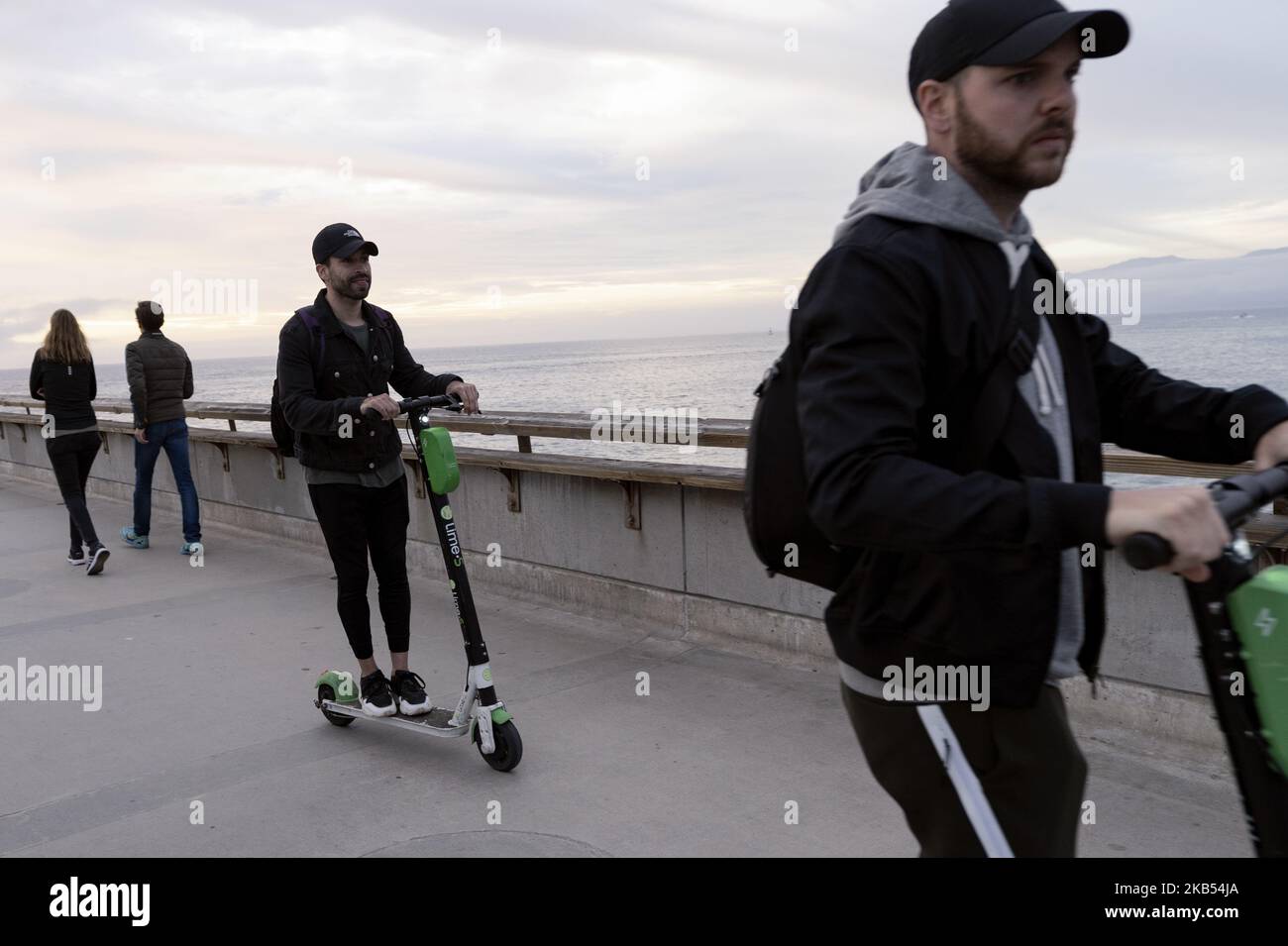 People ride electric scooters in Los Angeles, California on January 29 ...