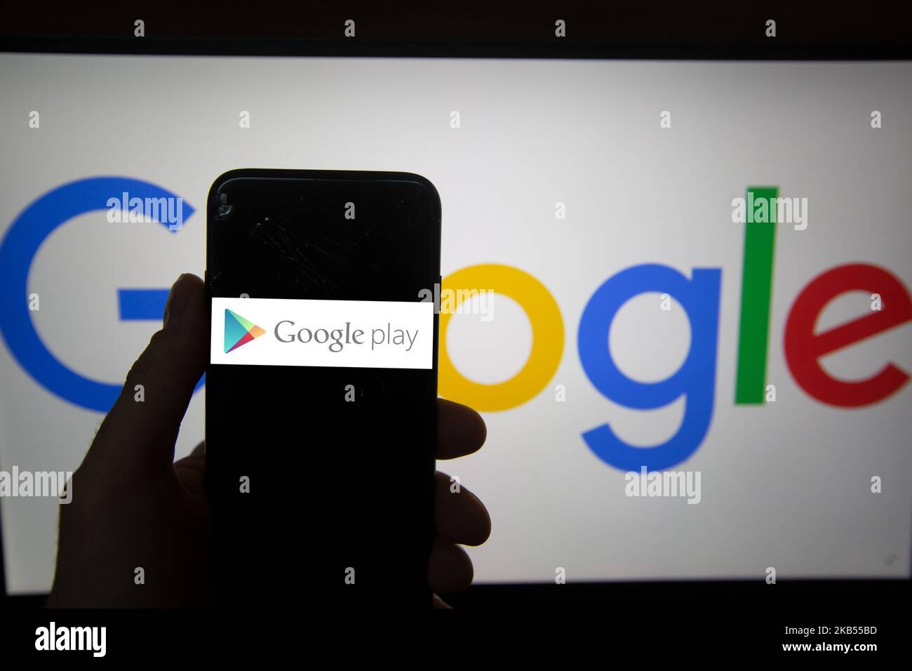 The logo of Google Play is seen on a screen. In the background there is ...