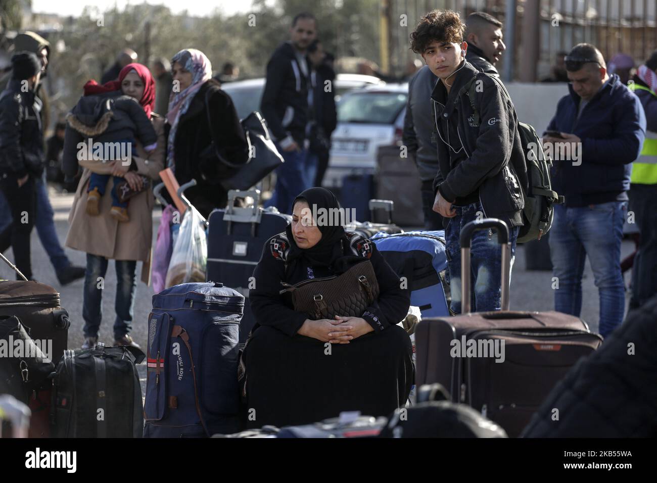 Palestinians wait to cross to Egypt through the Rafah border crossing ...