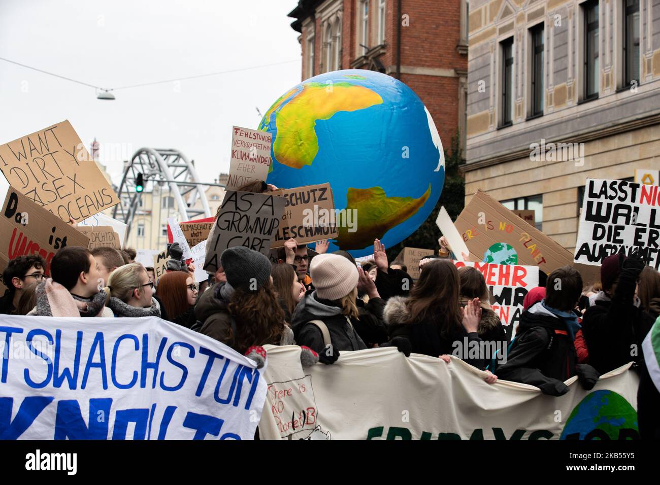Activists with colorful signs and a huge plastic earth. 600 young ...