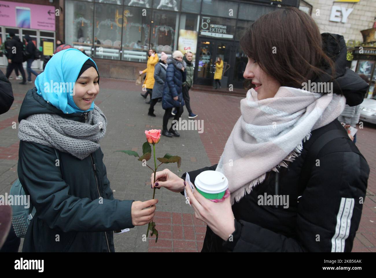 An Ukrainian muslim girl (L) presents a rose to a girl (R) during a ...