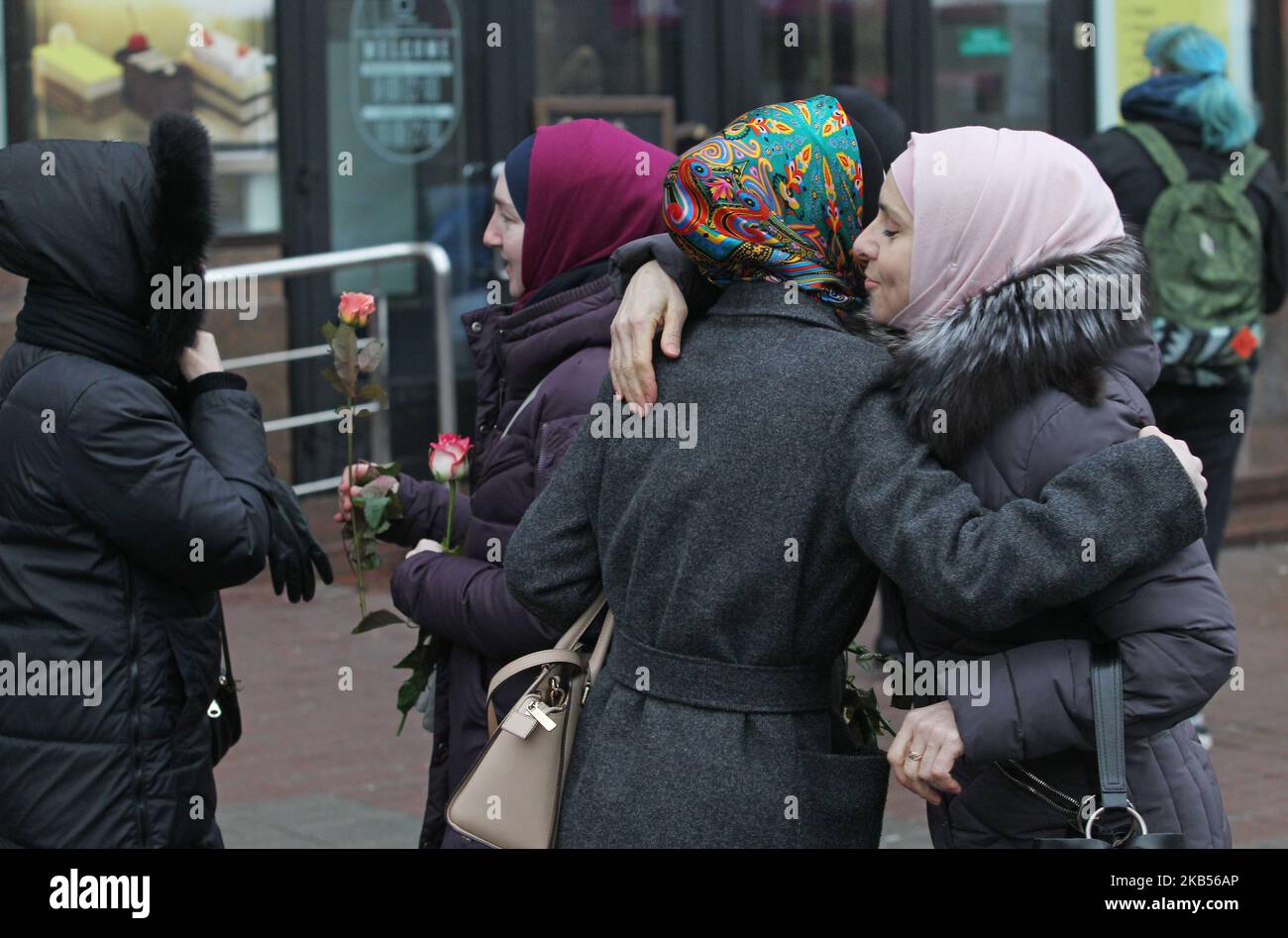 Ukrainian muslim women present flowers to women during their a ...