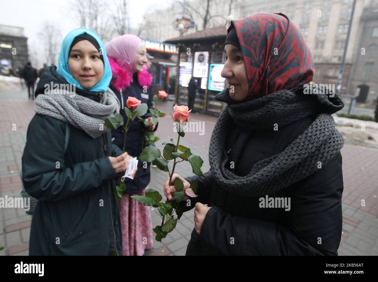 Ukrainian muslim women present flowers to women during their a ...