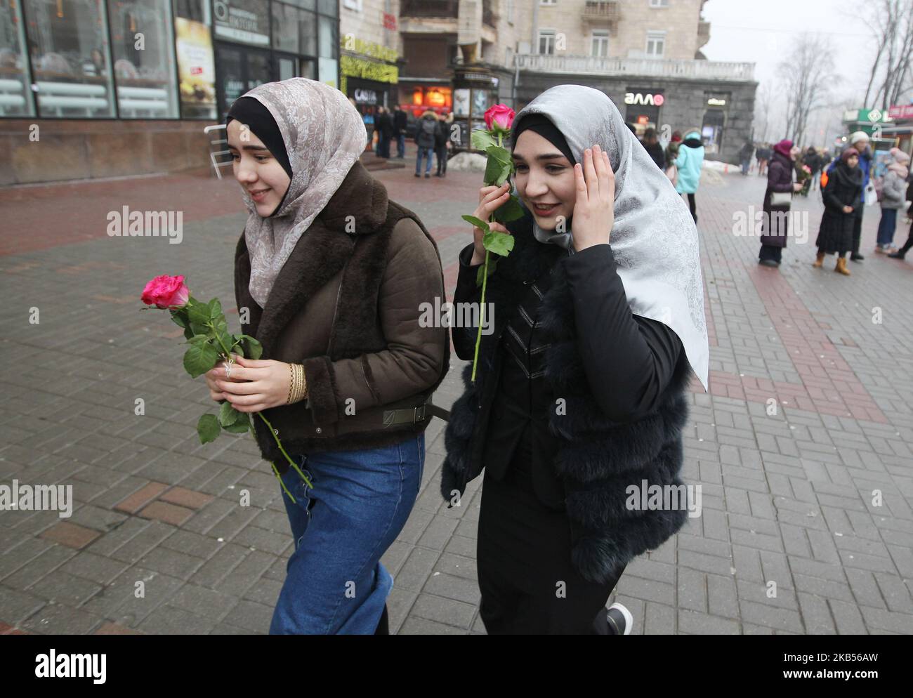 Ukrainian muslim women present flowers to women during their a ...