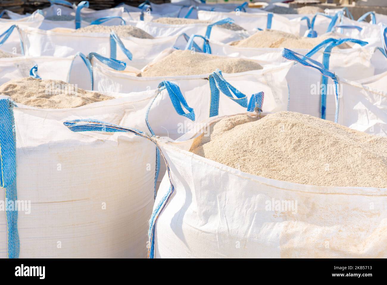 Bags of building mix at hardware store warehouse Stock Photo - Alamy