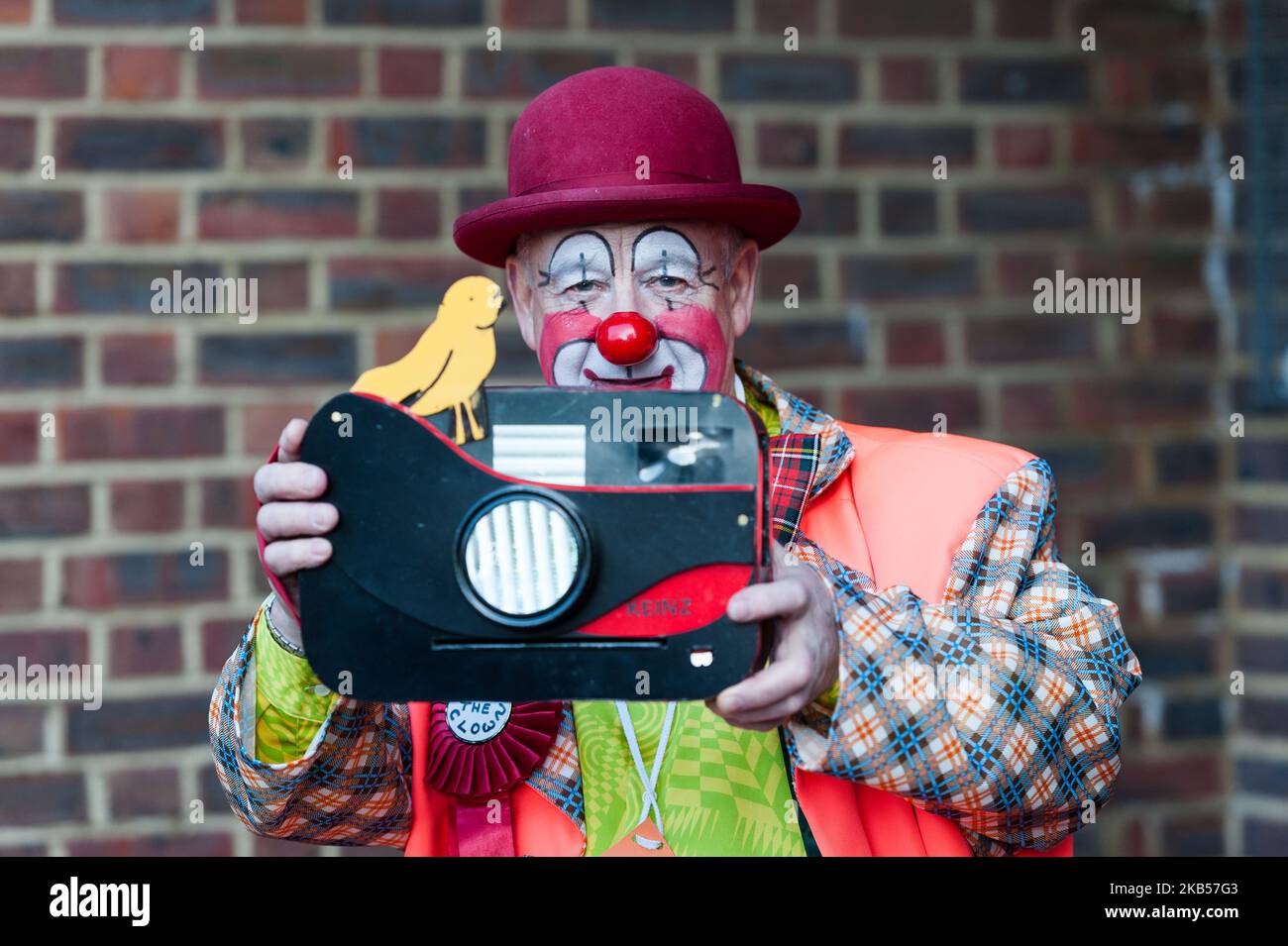 Clown with a fake camera poses for a photo outside the All Saints ...
