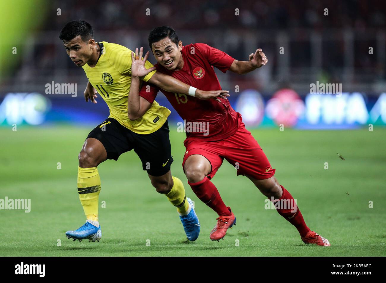 Ricky Fajrin Saputra (right) of Indonesian's in action during FIFA World Cup 2022 qualifying ...