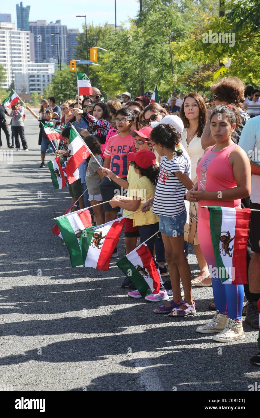 Iranian Canadians hold Iranian flags during the first ever Persian ...