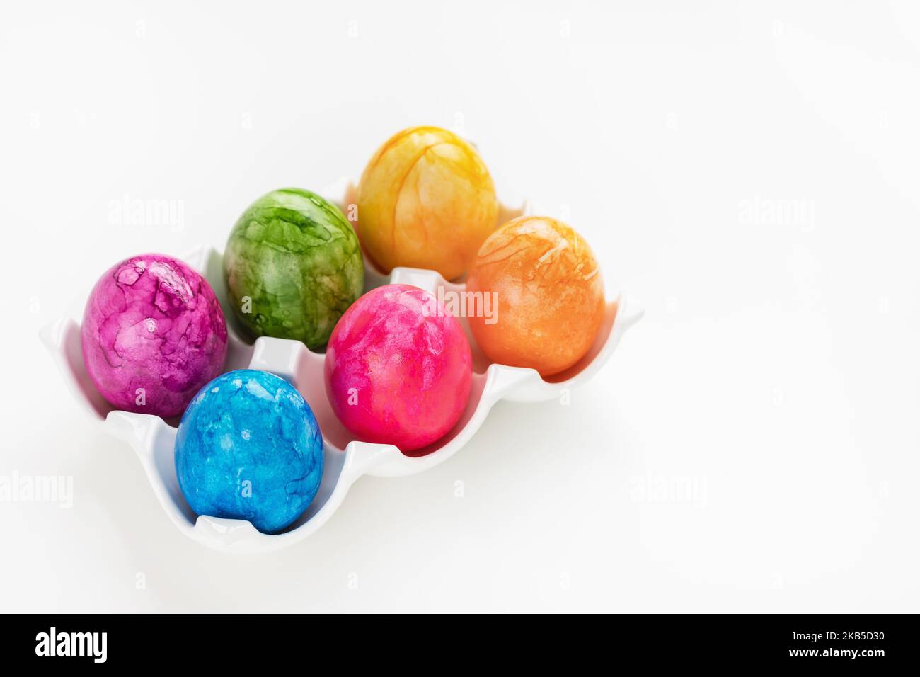 Colorful six Easter eggs in porcelain storage organizer box on white ...