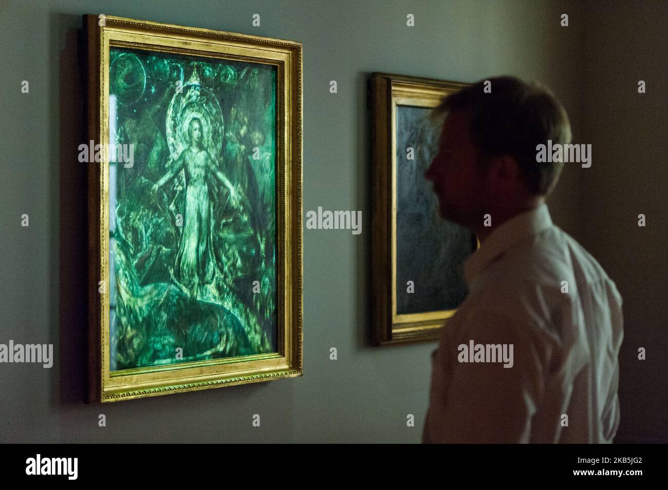 A gallery staff member views "The Spiritual Form of Pitt Guiding ...