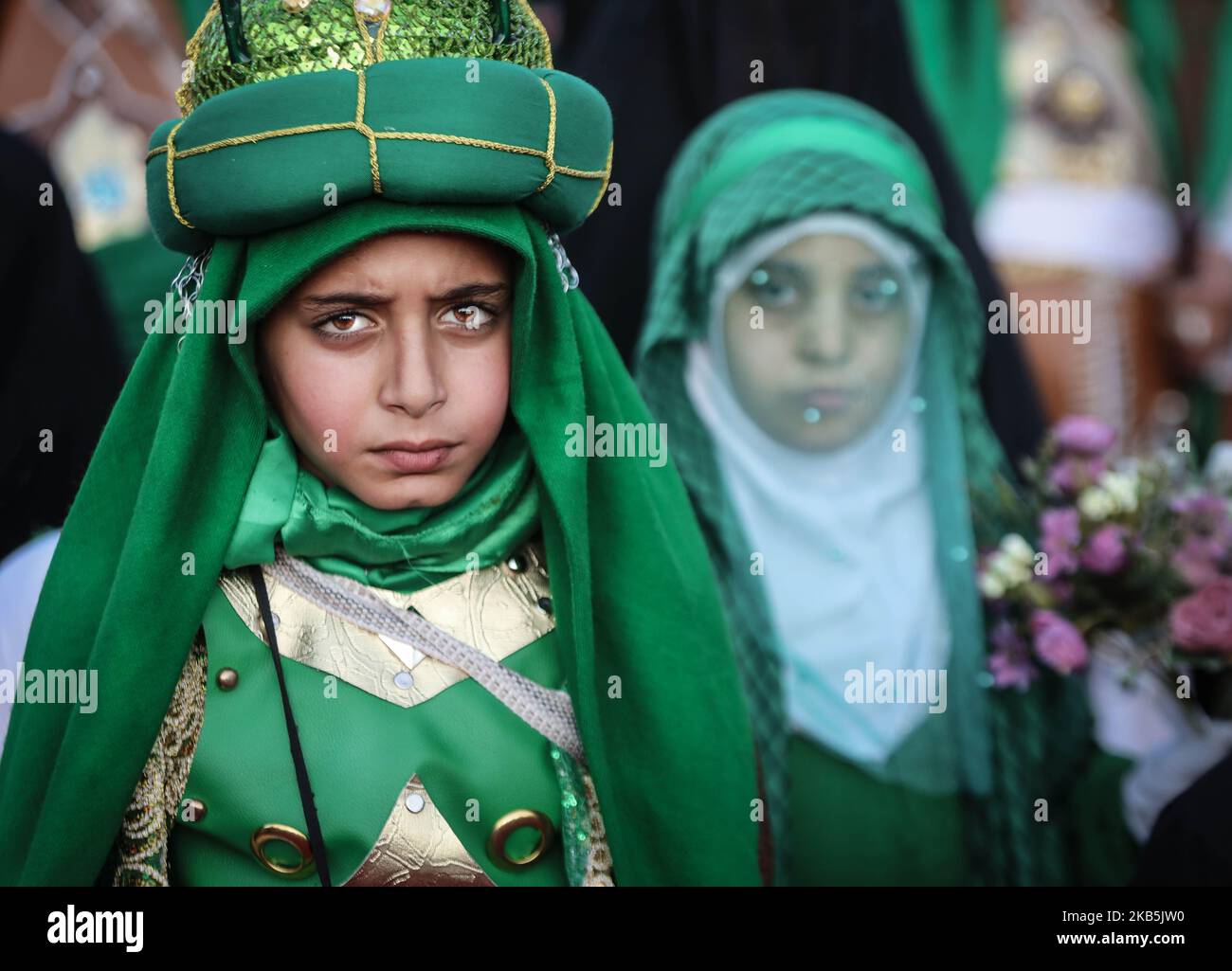 Shiite Muslim pilgrims dressed in historical clothing take part in a ...