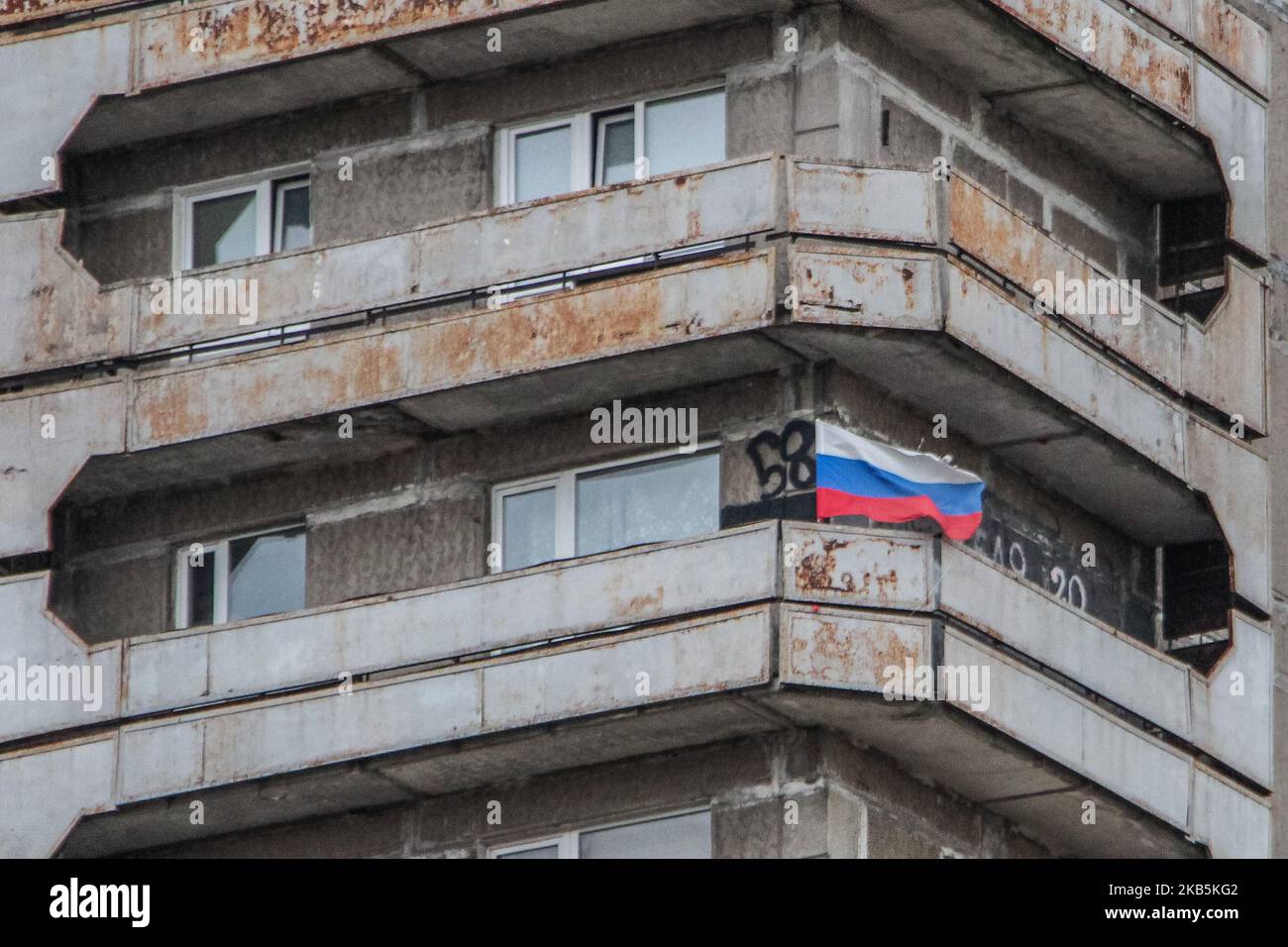 Russian Federation flag on the wind on the balcony on Soviet era block ...