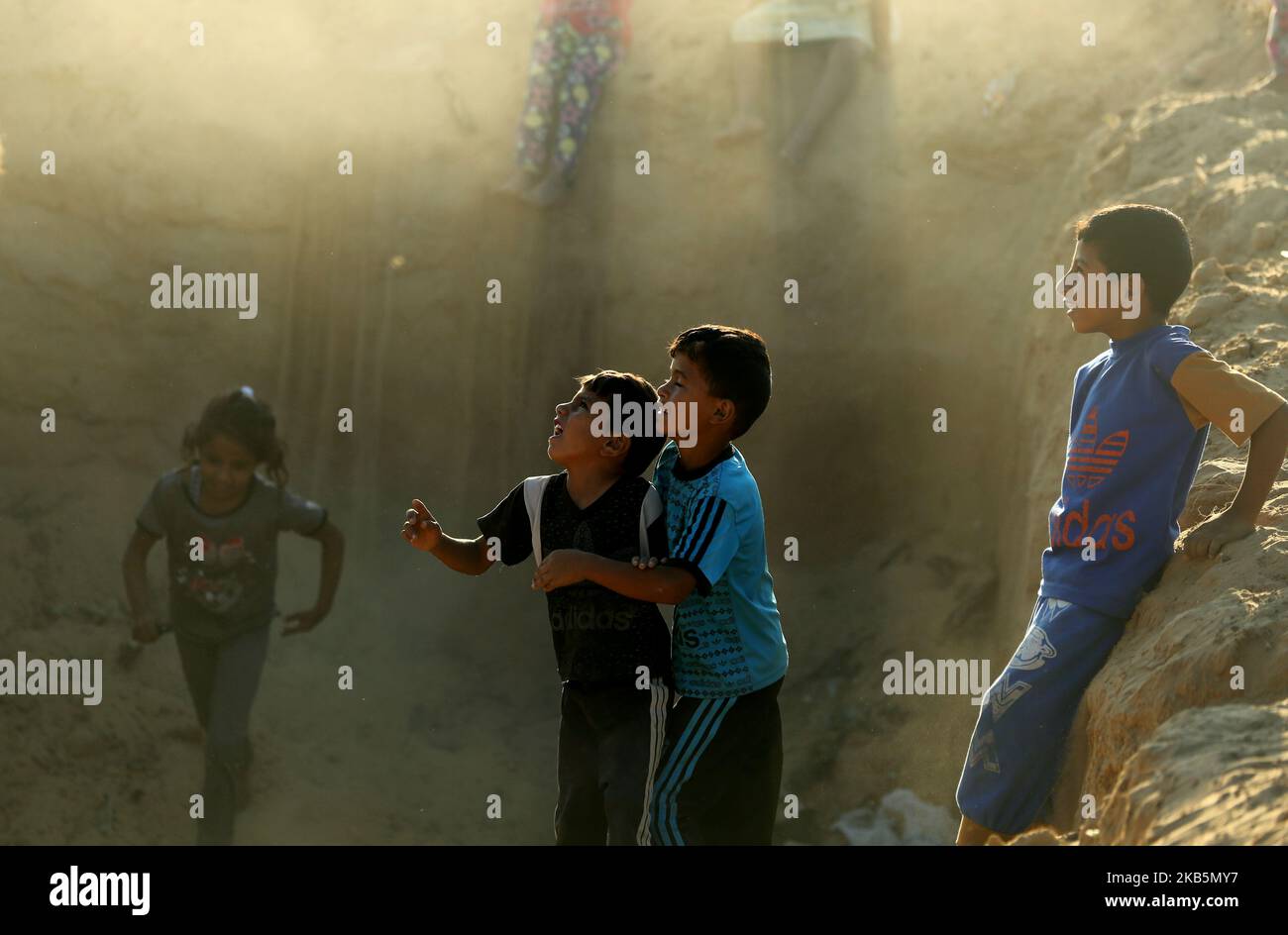 Palestinian children play on the land of Gaza destroyed airport, in ...