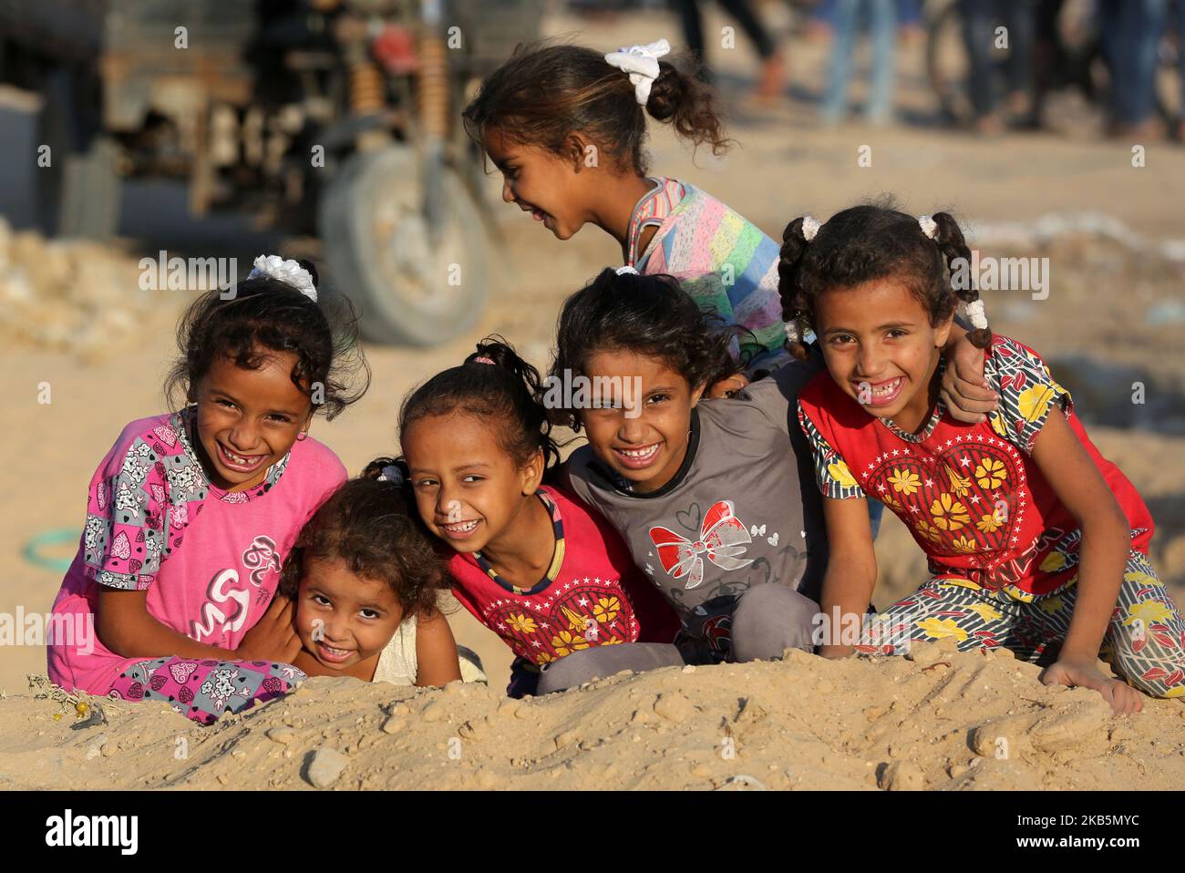 Palestinian children play on the land of Gaza destroyed airport, in ...