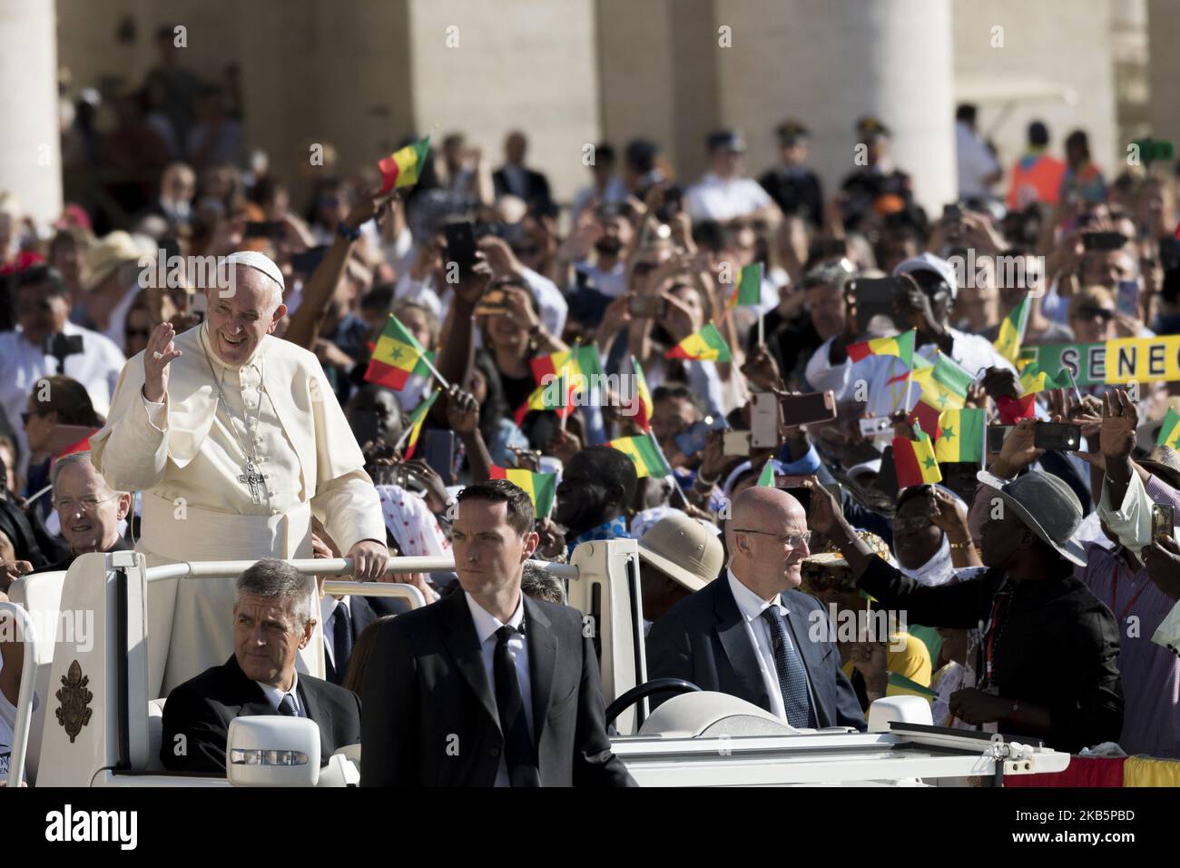 Pope Francis smiles as he arrives for his weekly general audience at St ...