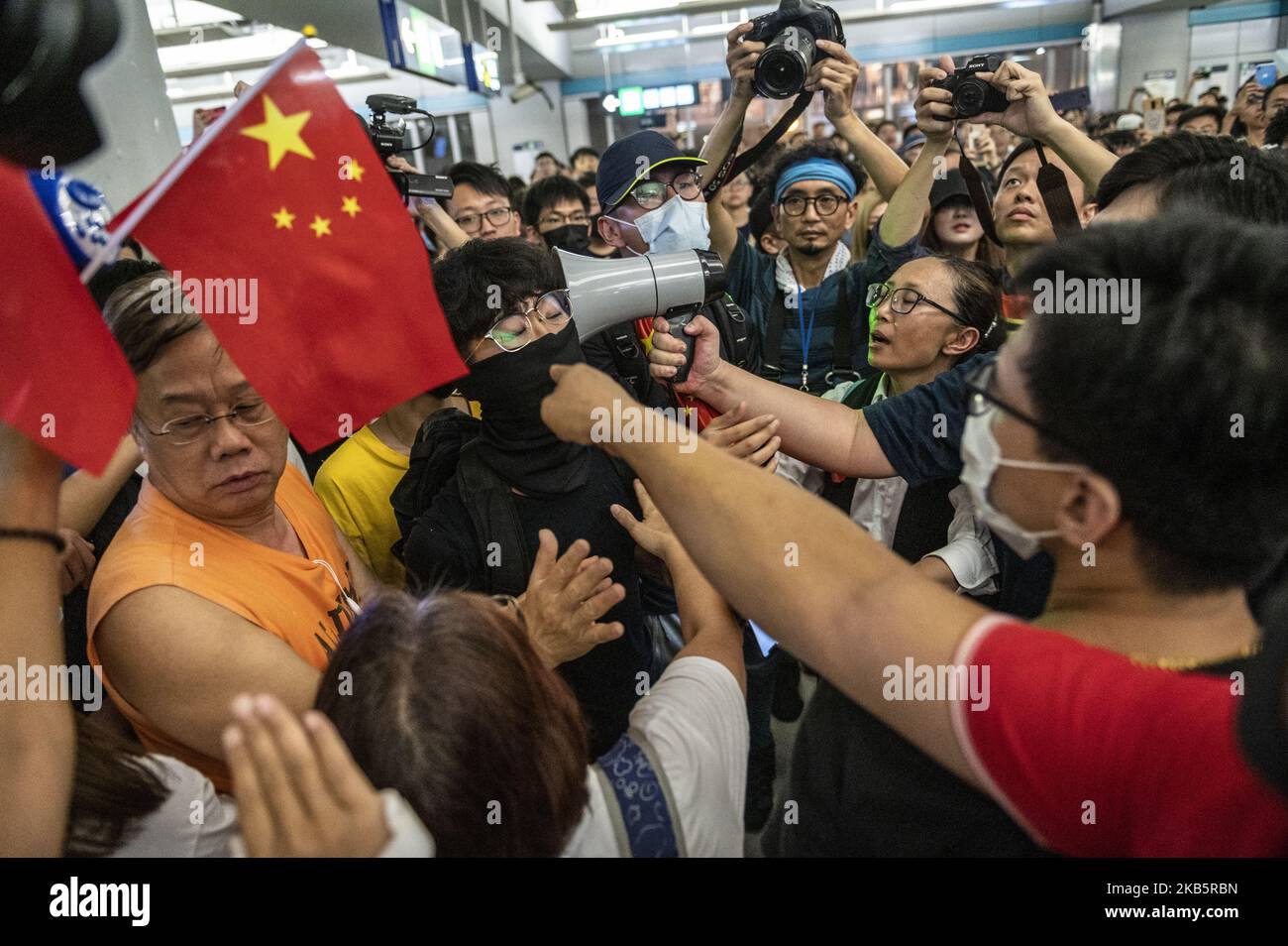 Pro-Beijing Protester are seen surrounding a Pro-Democracy inside an ...