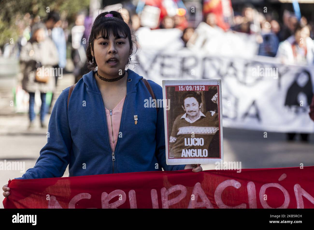 Activists of Chilean human rights organizations hold portraits of ...