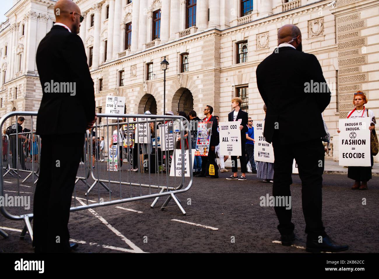 Security guards look on as members of climate change activist group ...