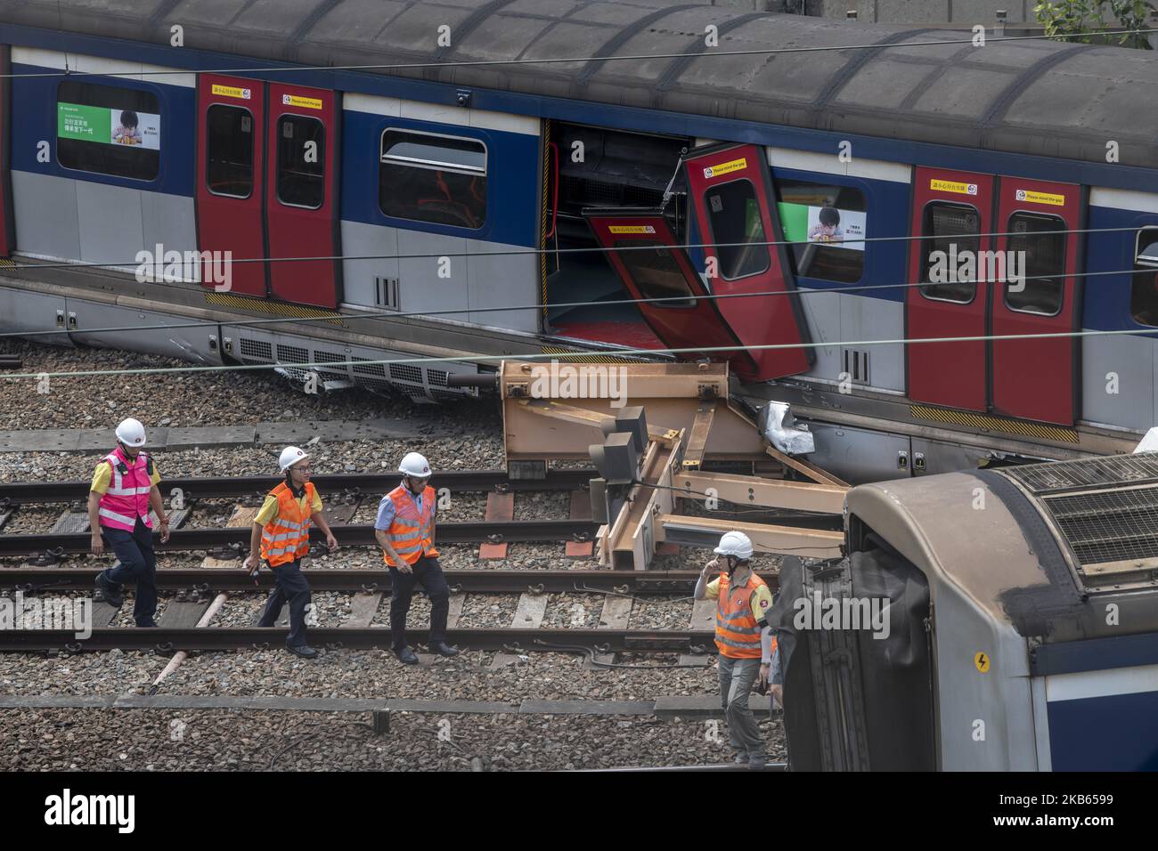 MTR Staff are seen walking pass a Derailed MTR Passengers Train near ...