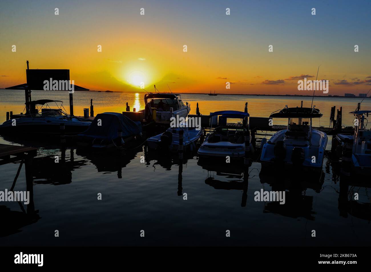 boats are seen at sunset on a boardwalk on September 18, 2019 in Cancun ...