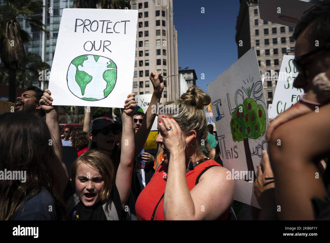 Protesters march and hold placards during the Global Climate Strike ...