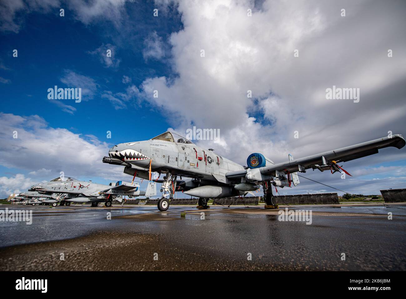 A row of A-10C Thunderbolt II aircraft sit on the flight line at ...