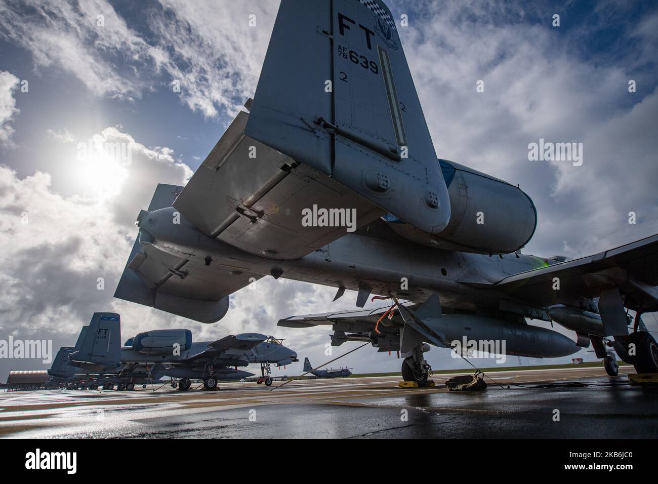 A row of A-10C Thunderbolt II aircraft sit on the flightline at ...