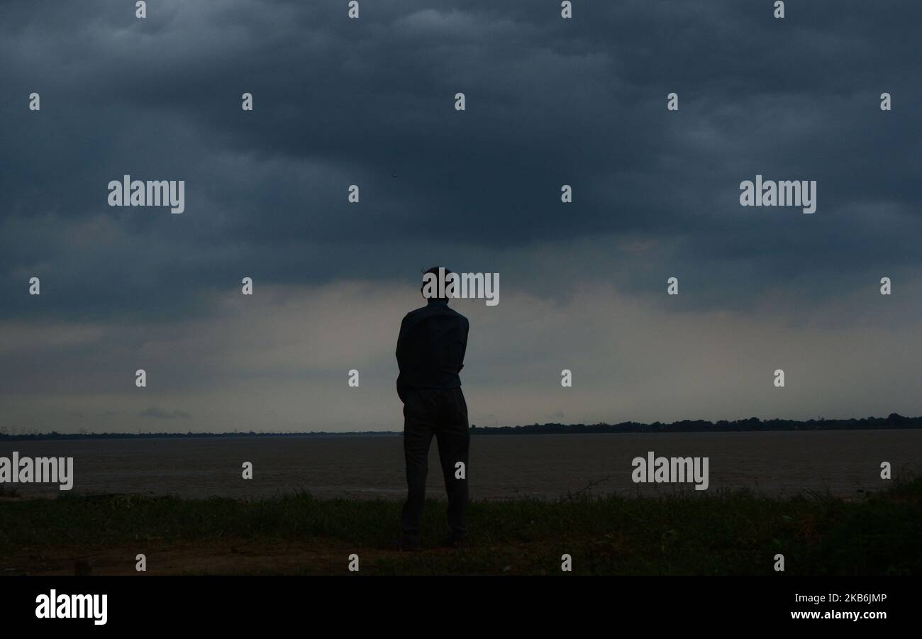An indian villager stands on the banks of over flooded Ganges river in ...