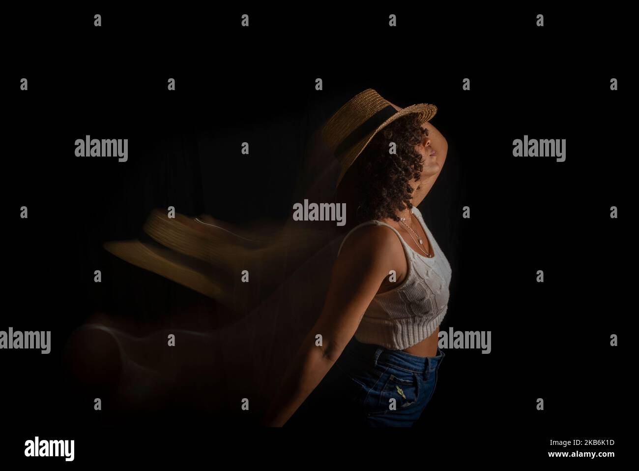 Time-lapse view of woman moving a hat. Long exposure, motion blur ...