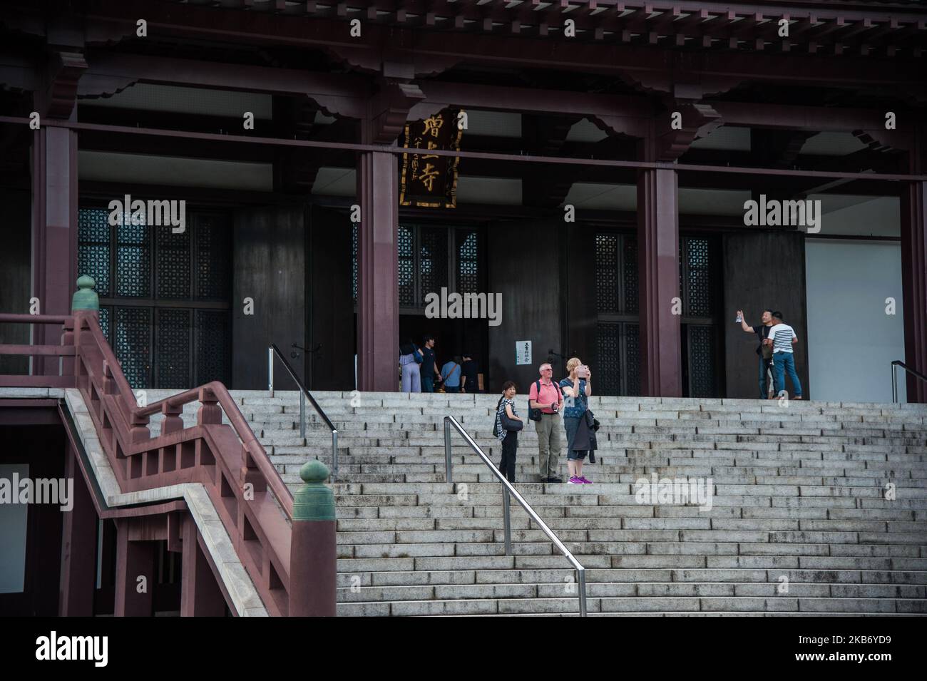 People are seen walking in the area of a temple near Tokyo tower. Daily ...