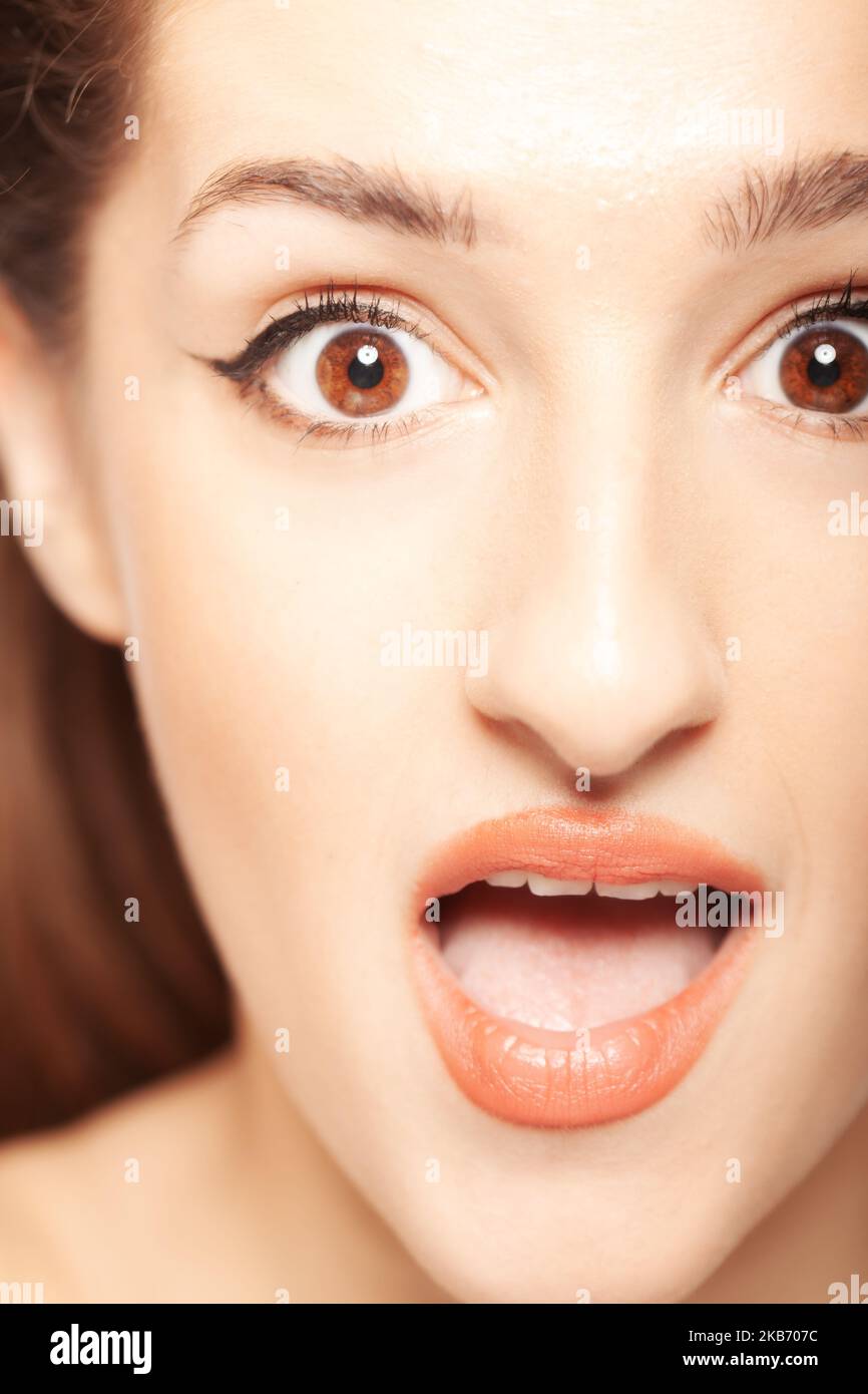 Beautiful girl studio portrait. Making suprised face expression Stock ...
