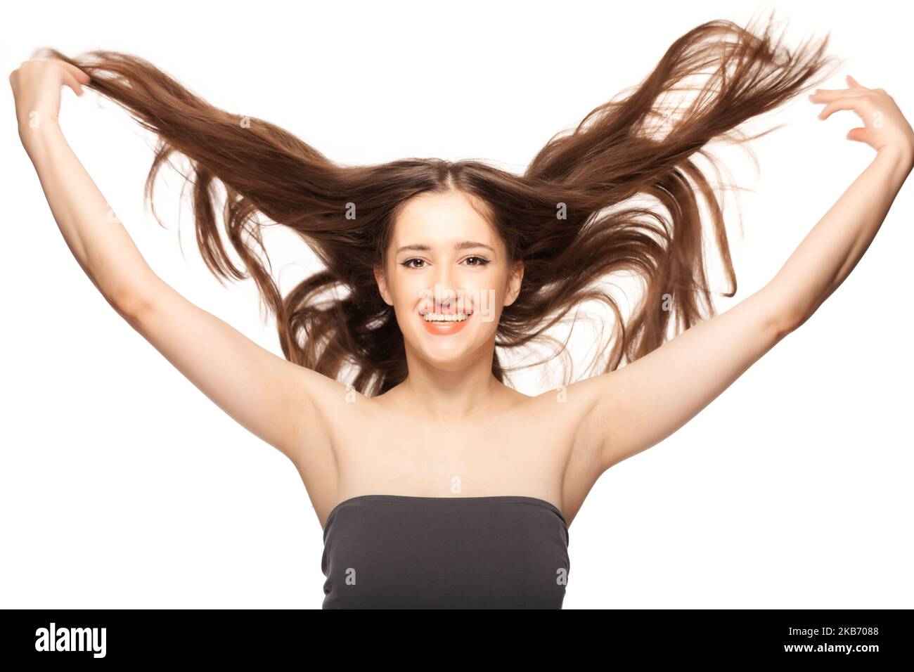 Beautiful girl close studio portrait against white background. Throwing ...