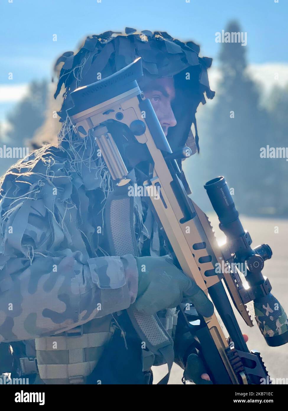 A Polish soldier assigned to the 151st Light Infantry Battalion, holds ...