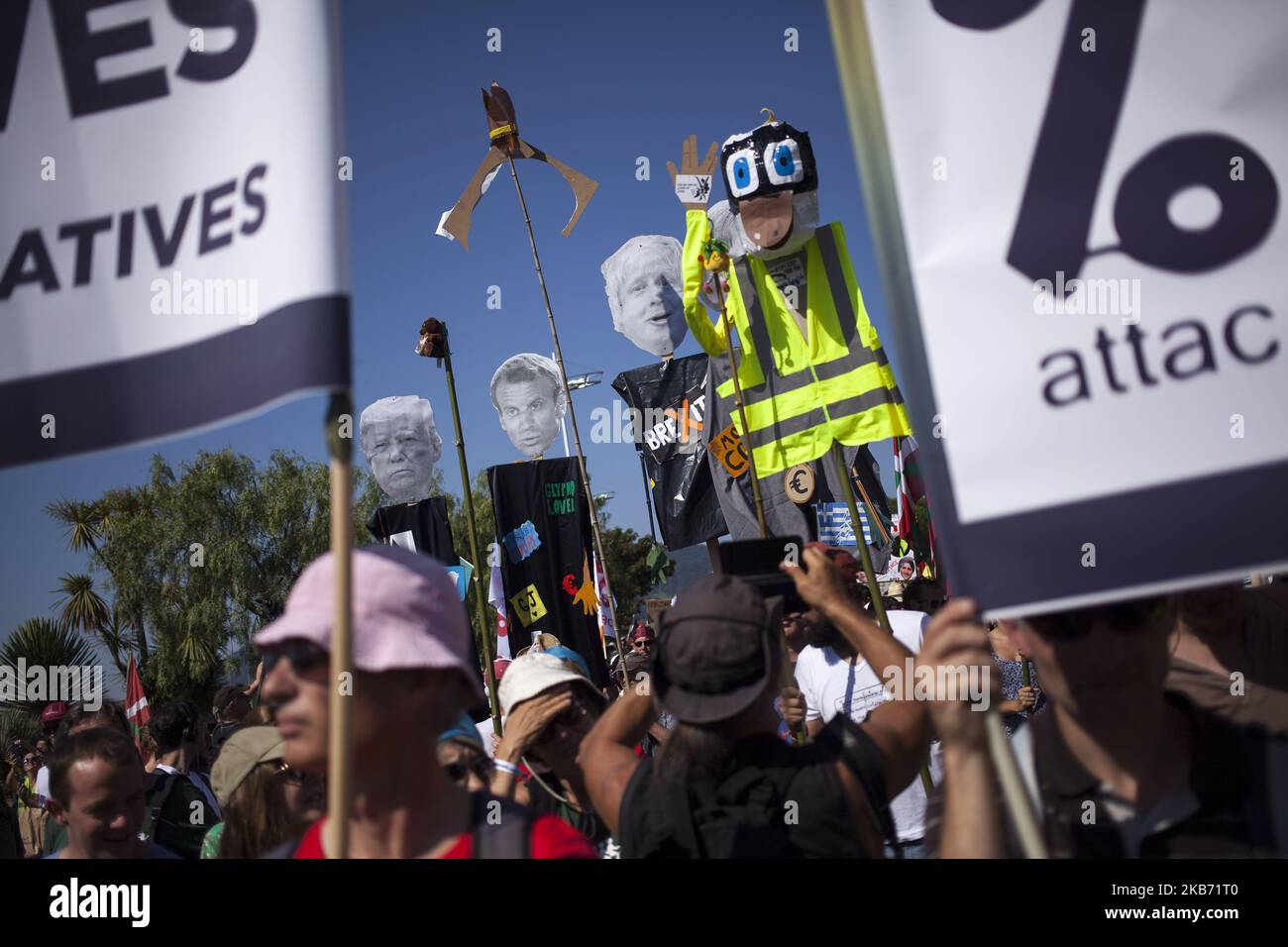 Protesters hold banners during anti G7 protest in Hendaye on 24 August ...