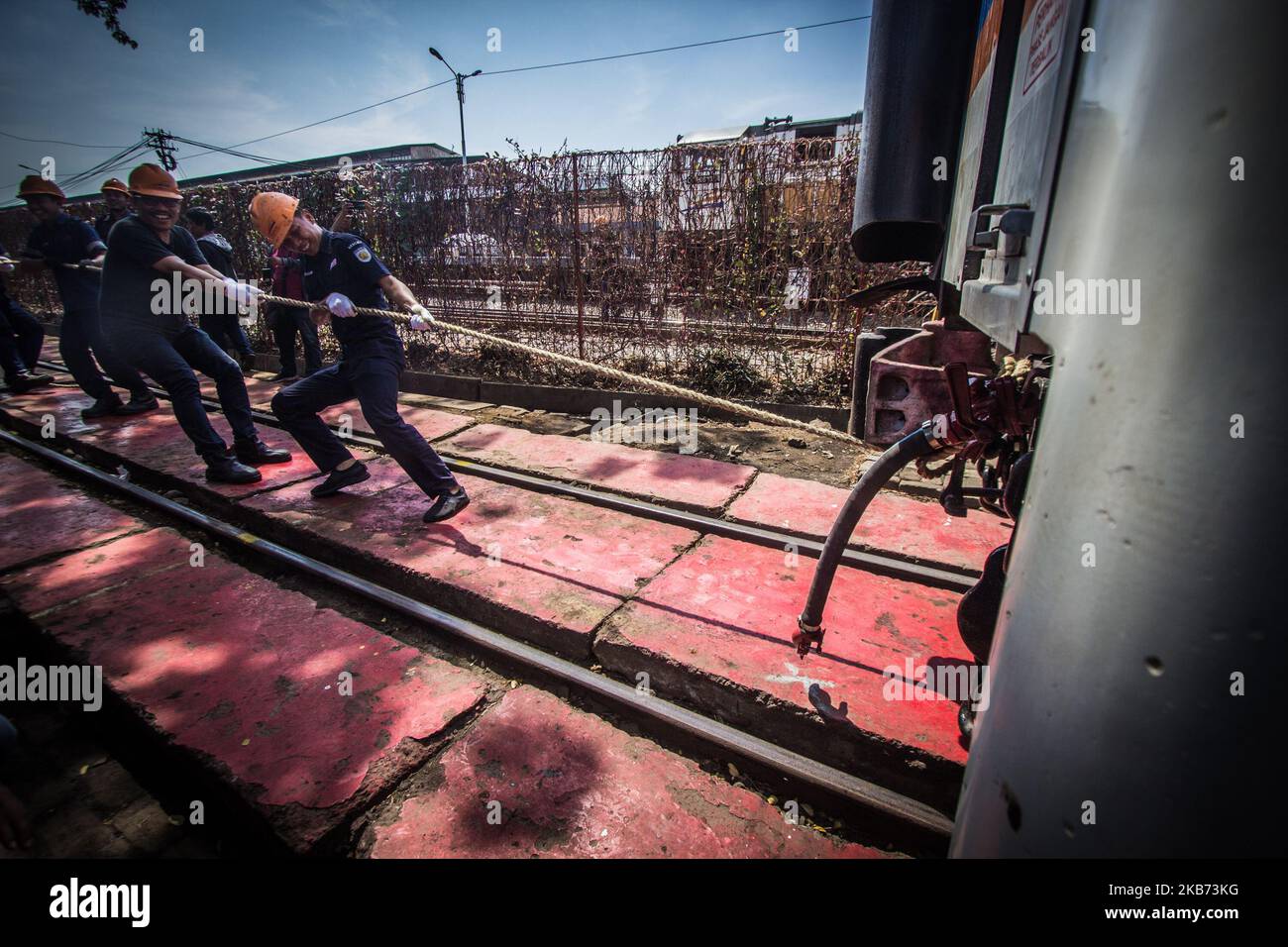 Participants take part in a train-pulling competition at local ...