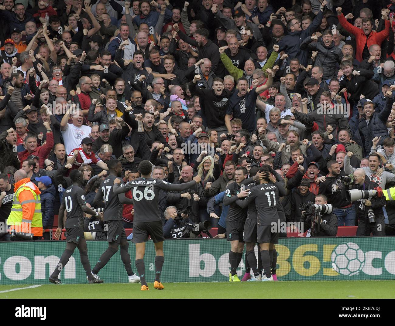 Liverpool celebrate in front of their fans after scoring at the English ...